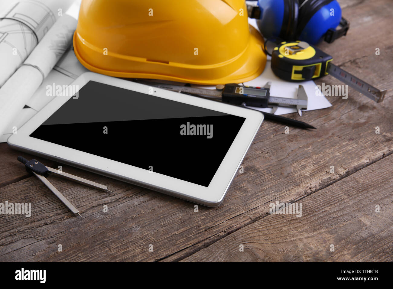 Tablet and blueprints on a white background Stock Photo - Alamy