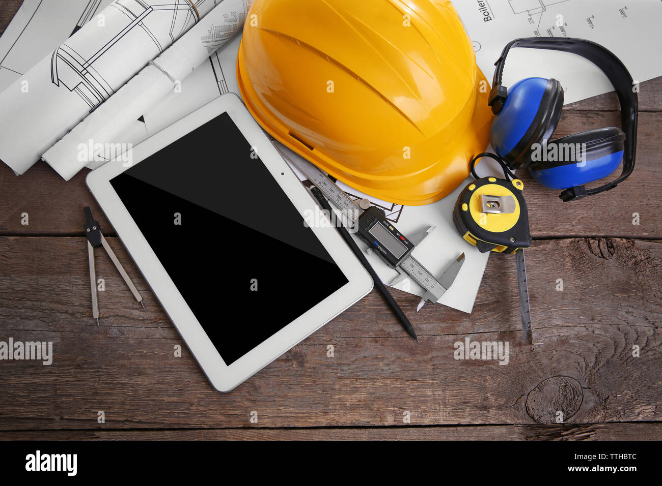 Tablet and blueprints on a white background Stock Photo - Alamy