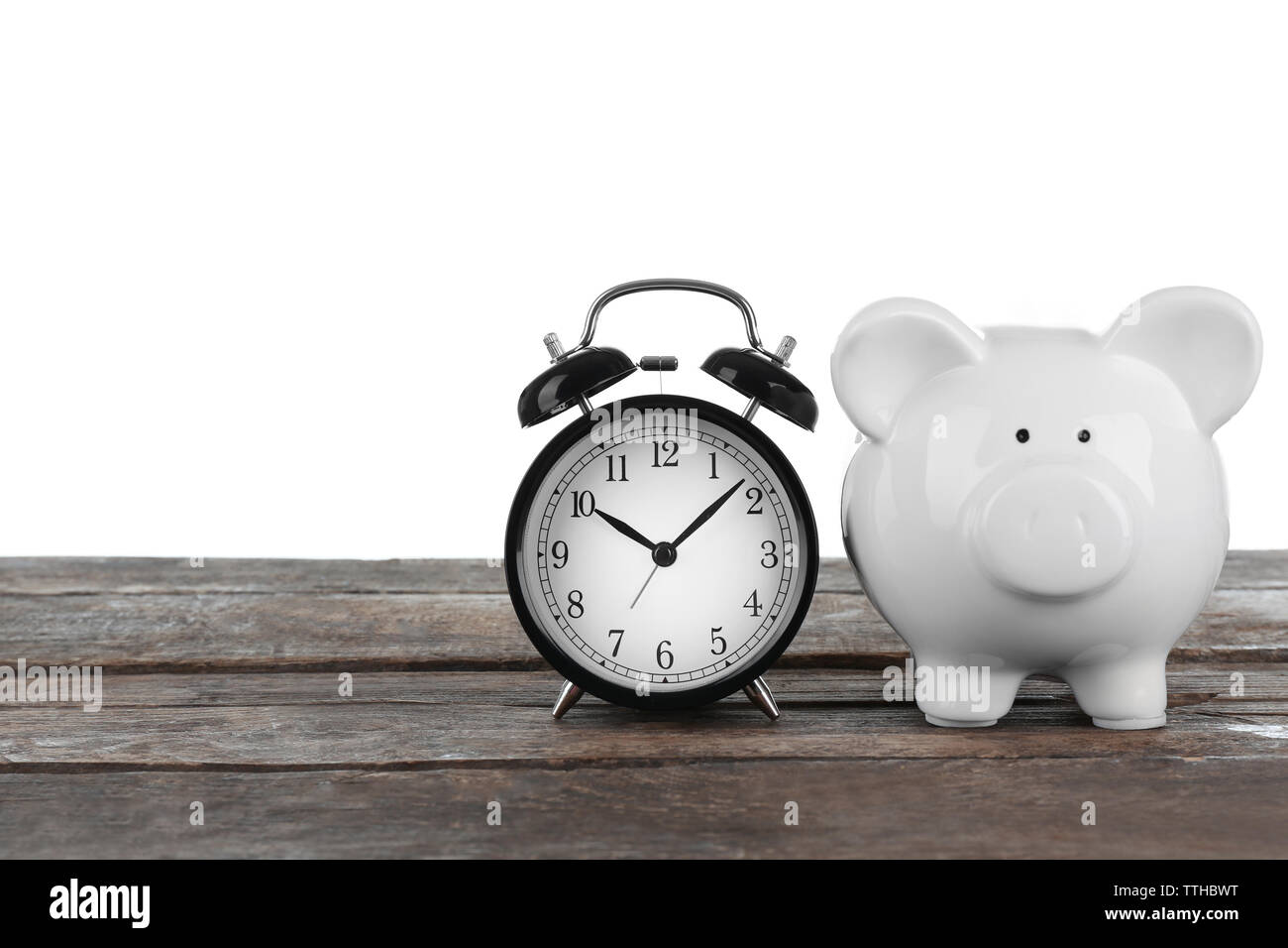 White piggy bank and clock on white background Stock Photo - Alamy