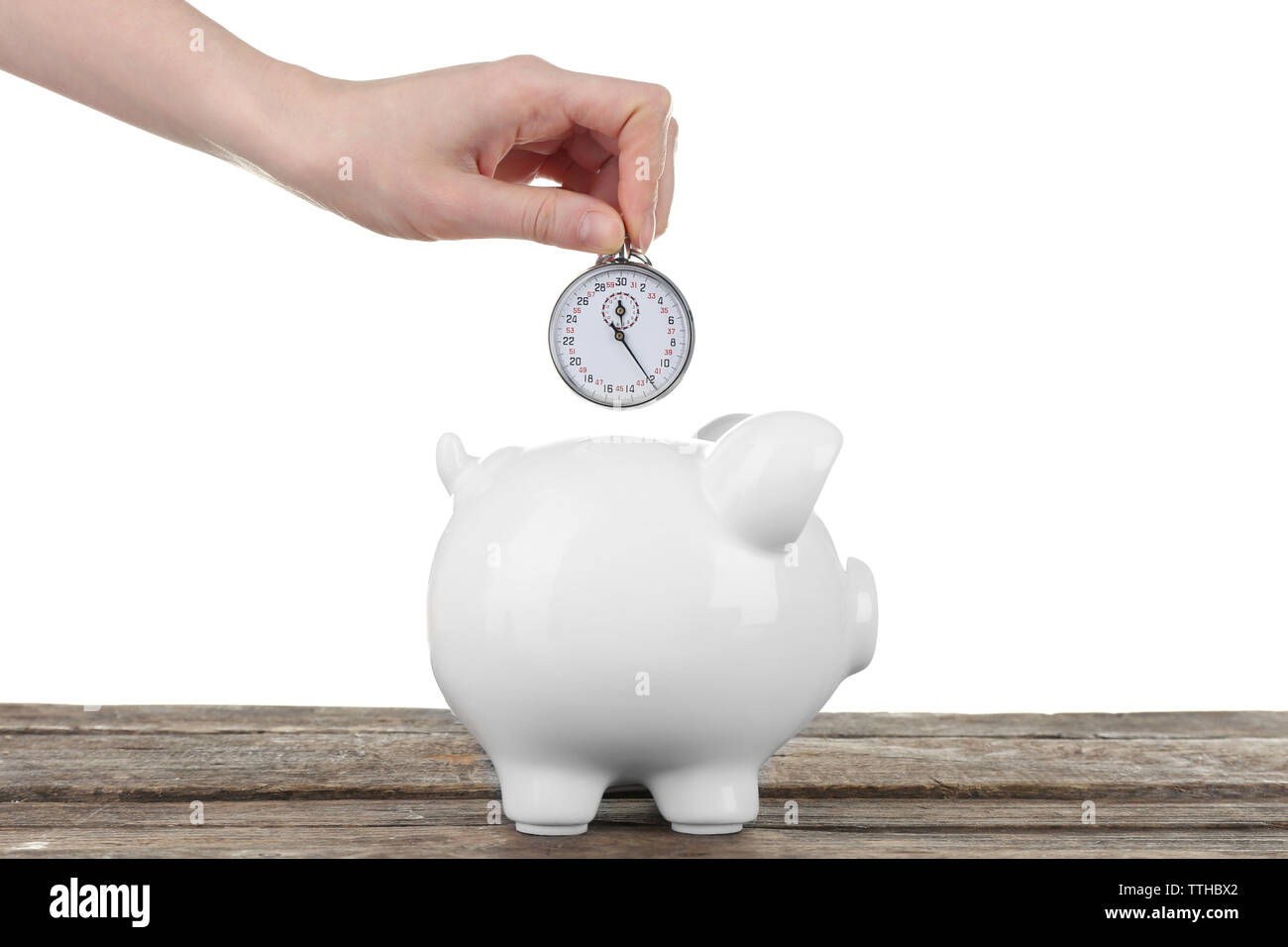 Piggy bank and a hand holding timer above it on white background Stock ...