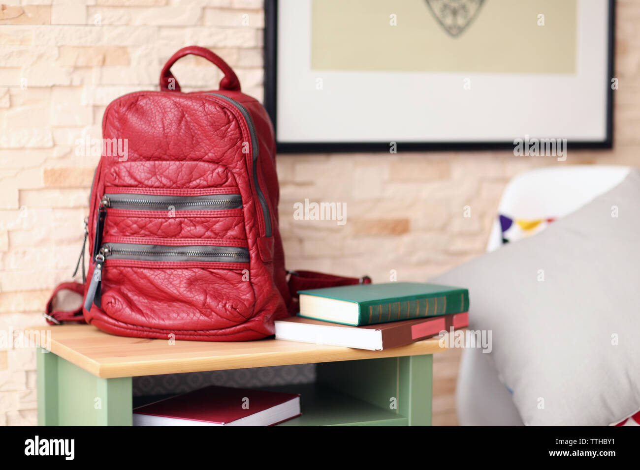 Red leather backpack on the table Stock Photo - Alamy