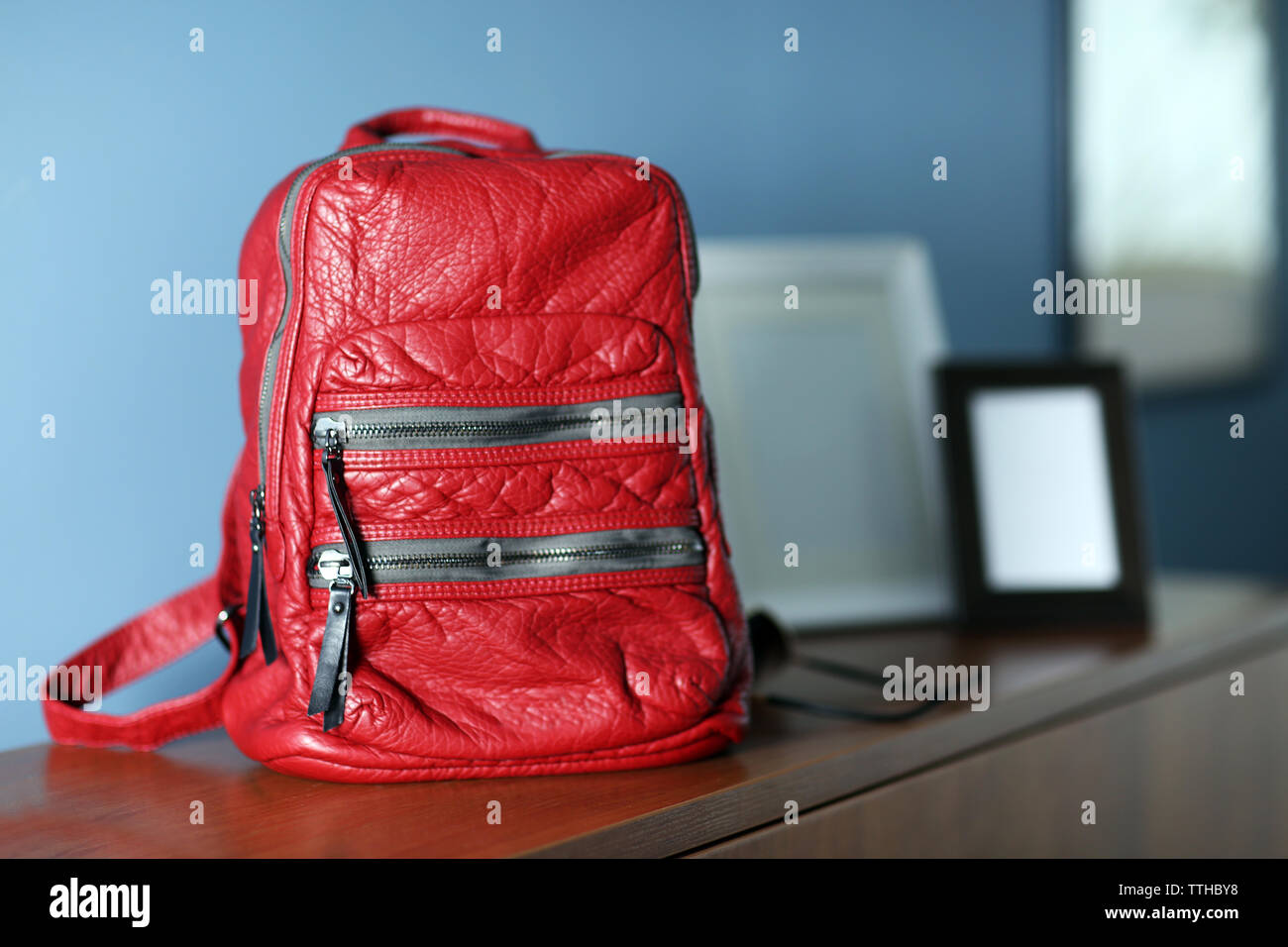 Red leather backpack on the table Stock Photo - Alamy