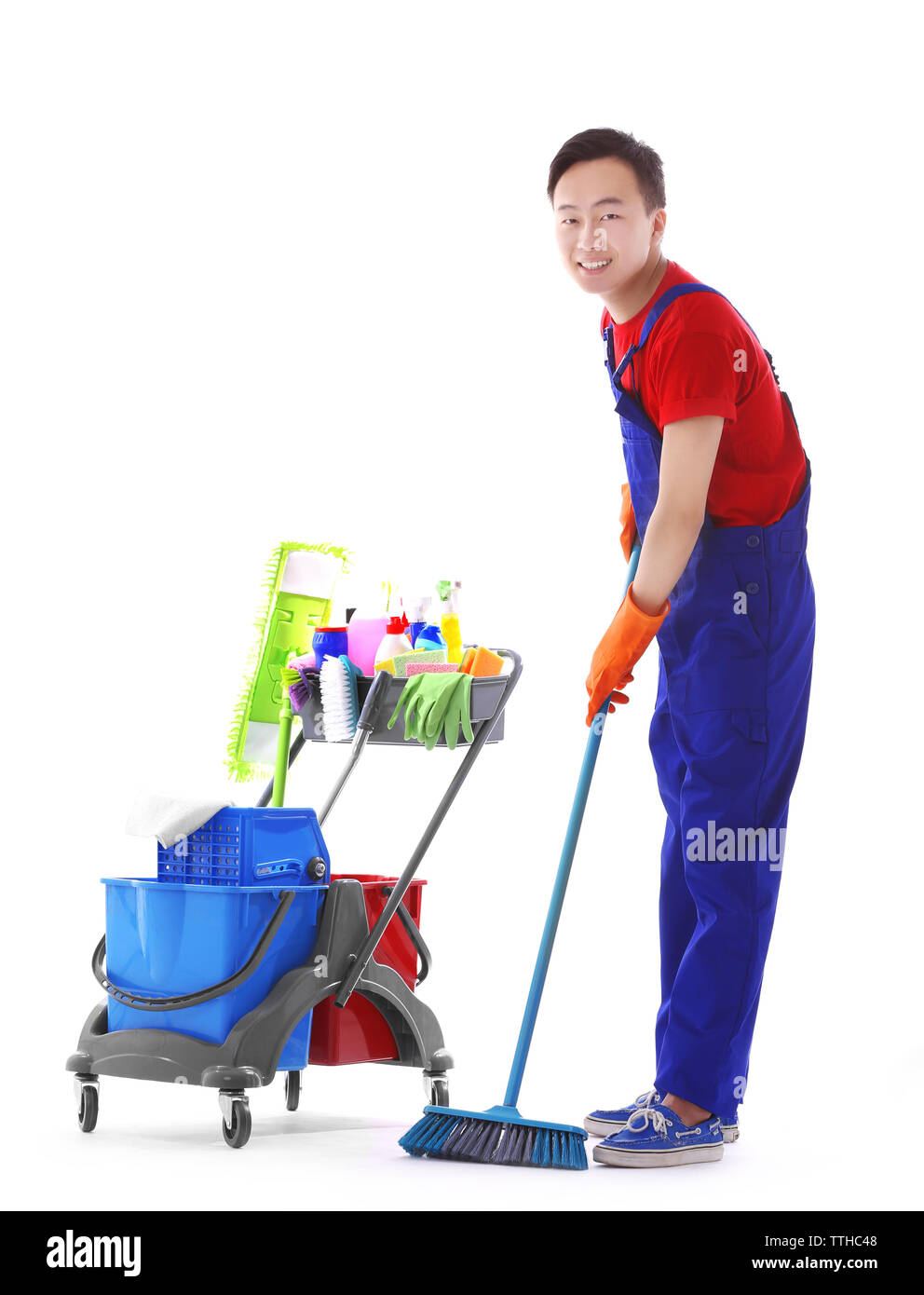Young smiling male cleaner isolated on white Stock Photo - Alamy