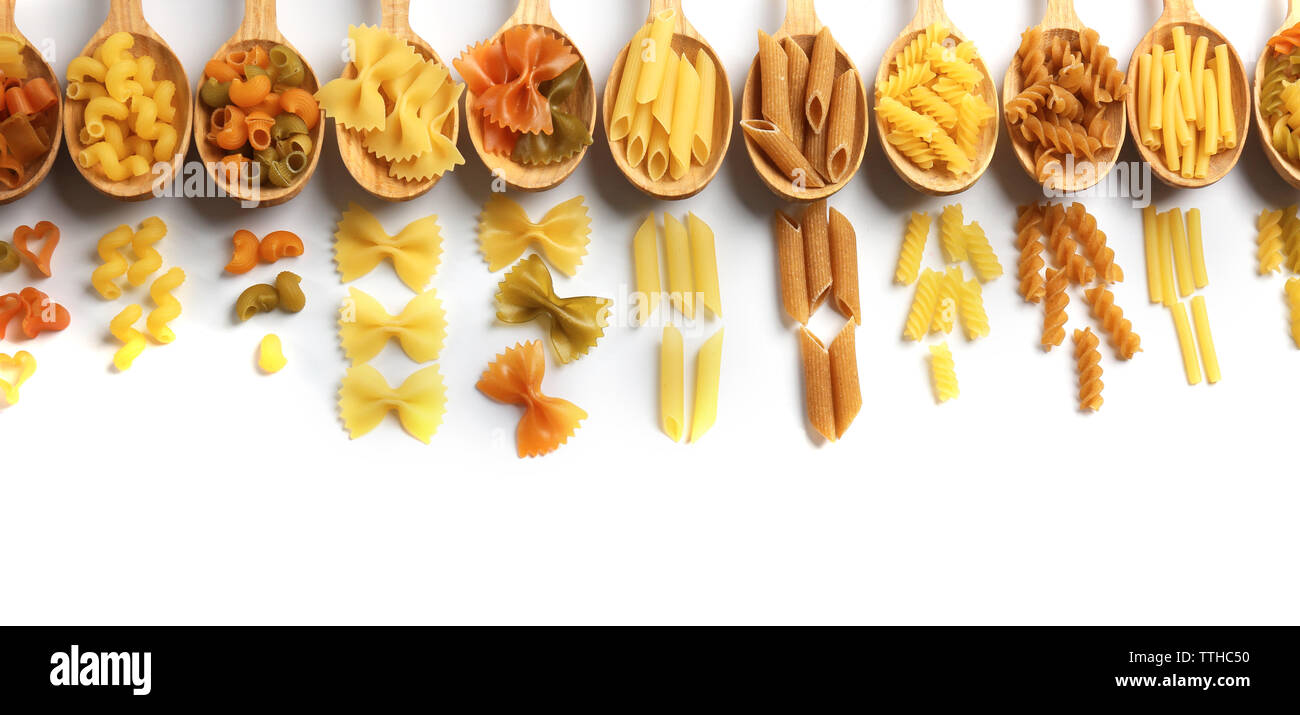 Different types of dry pasta in wooden spoons on white background Stock ...