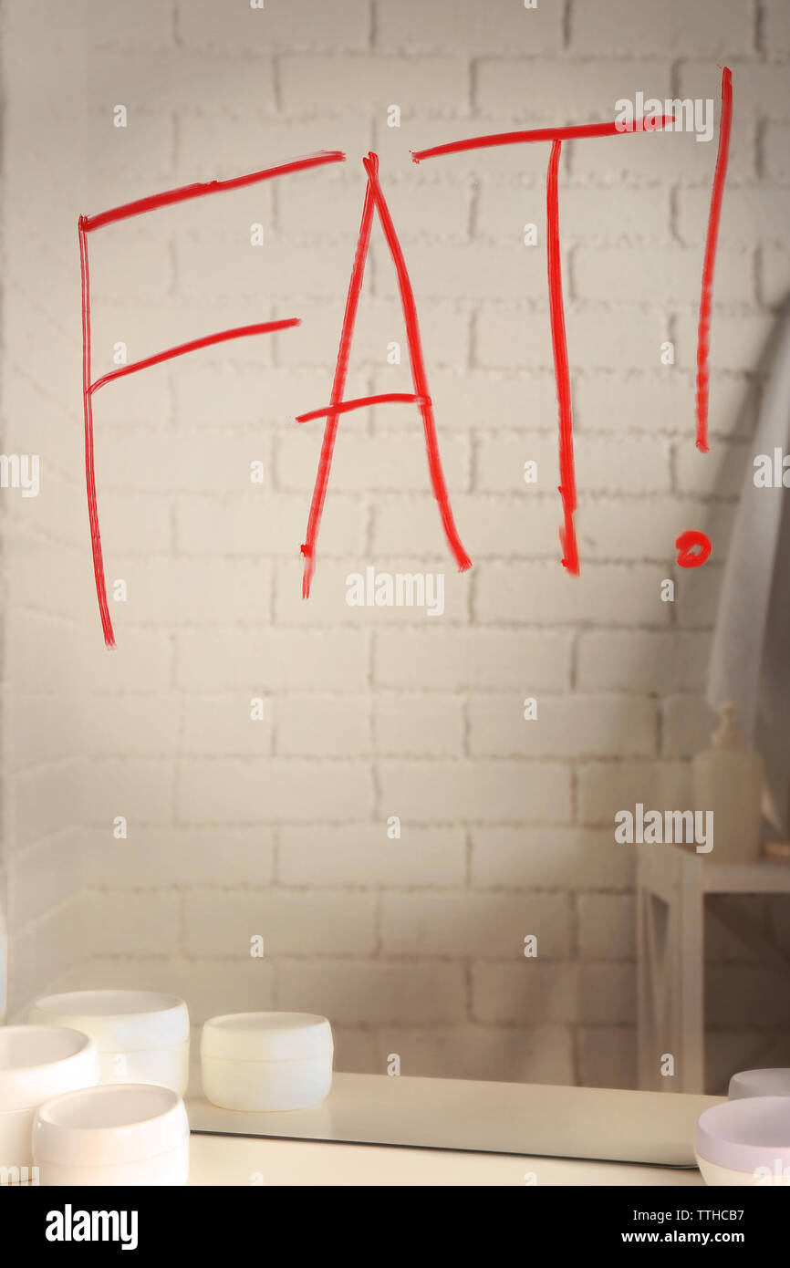Word FAT written on mirror in the bathroom Stock Photo - Alamy