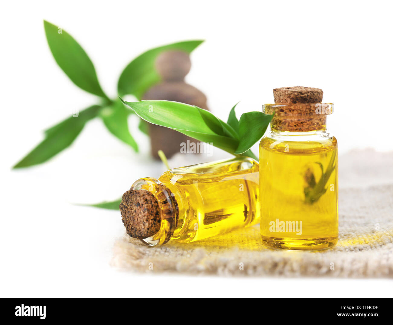 Bottles of tea oil, isolated on white Stock Photo - Alamy