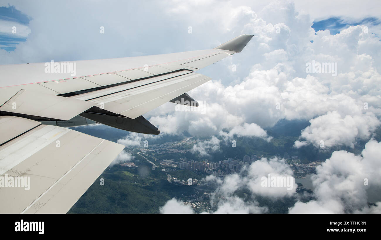 Aerial traveling. Flying through clouds. Ground under wing of an ...