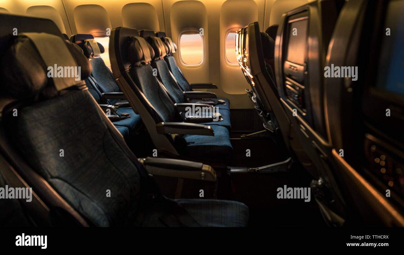Traveling by air. Inside at airplane empty cabin. Seats with beautiful ...