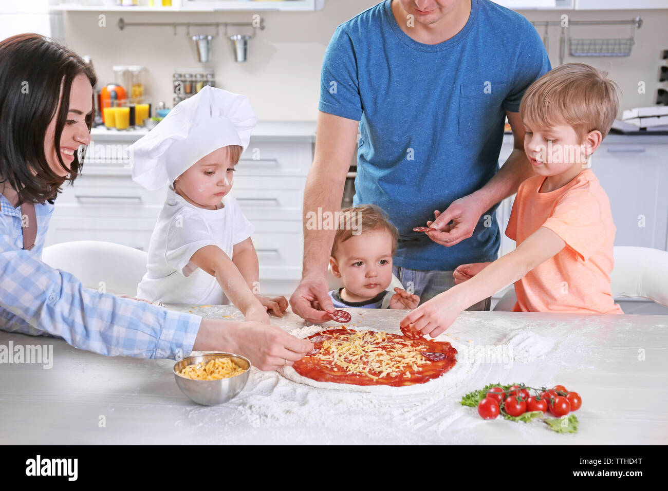Young family making a pizza, close up Stock Photo - Alamy