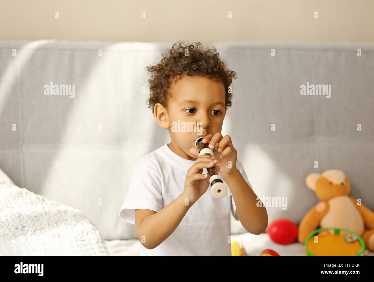 Little boy playing on recorder Stock Photo - Alamy