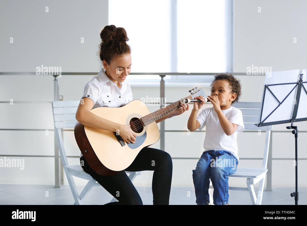 Young woman playing recorder instruments hi-res stock photography and ...