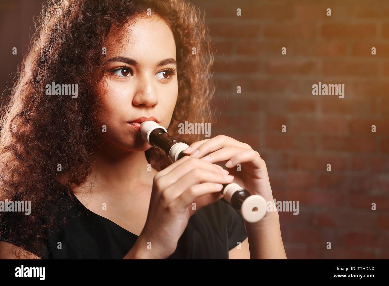 Young woman playing recorder hi-res stock photography and images - Alamy