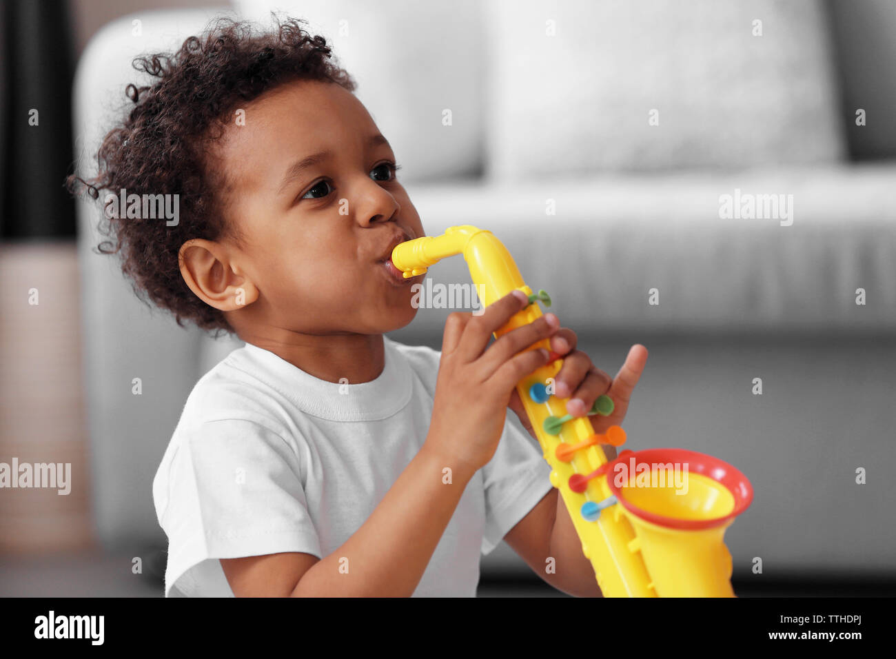 Little boy playing with musical toy Stock Photo - Alamy