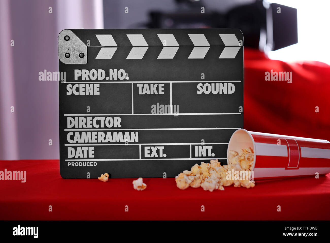 Movie clapper and popcorn on blurred background Stock Photo - Alamy