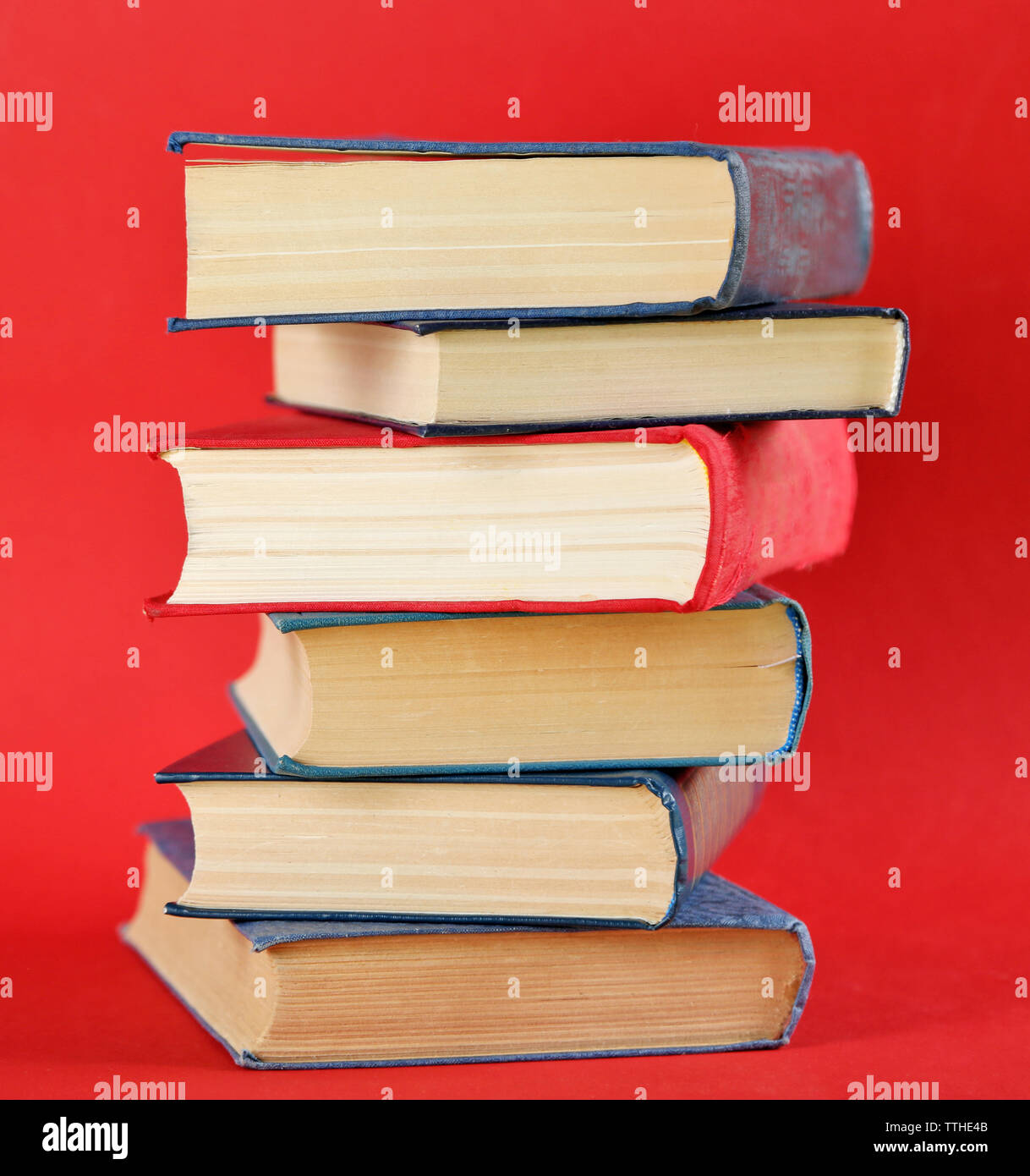 Stack of books on red background Stock Photo - Alamy