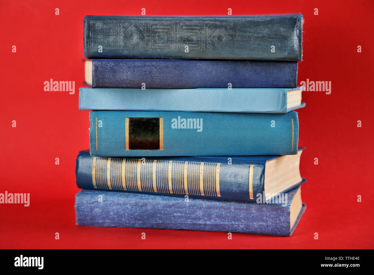 Stack of books on red background Stock Photo - Alamy