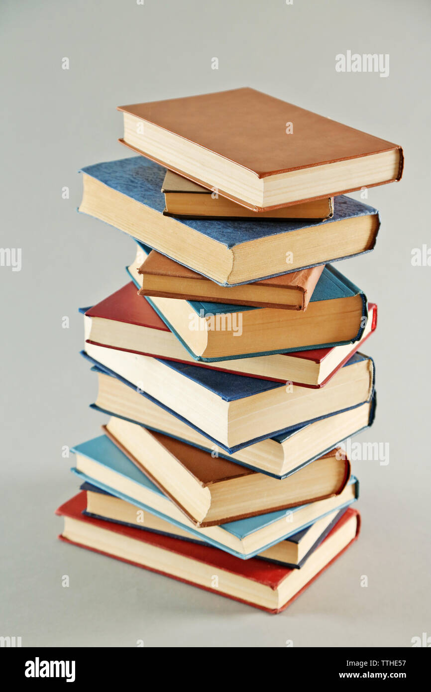 Stack of books on grey background Stock Photo - Alamy
