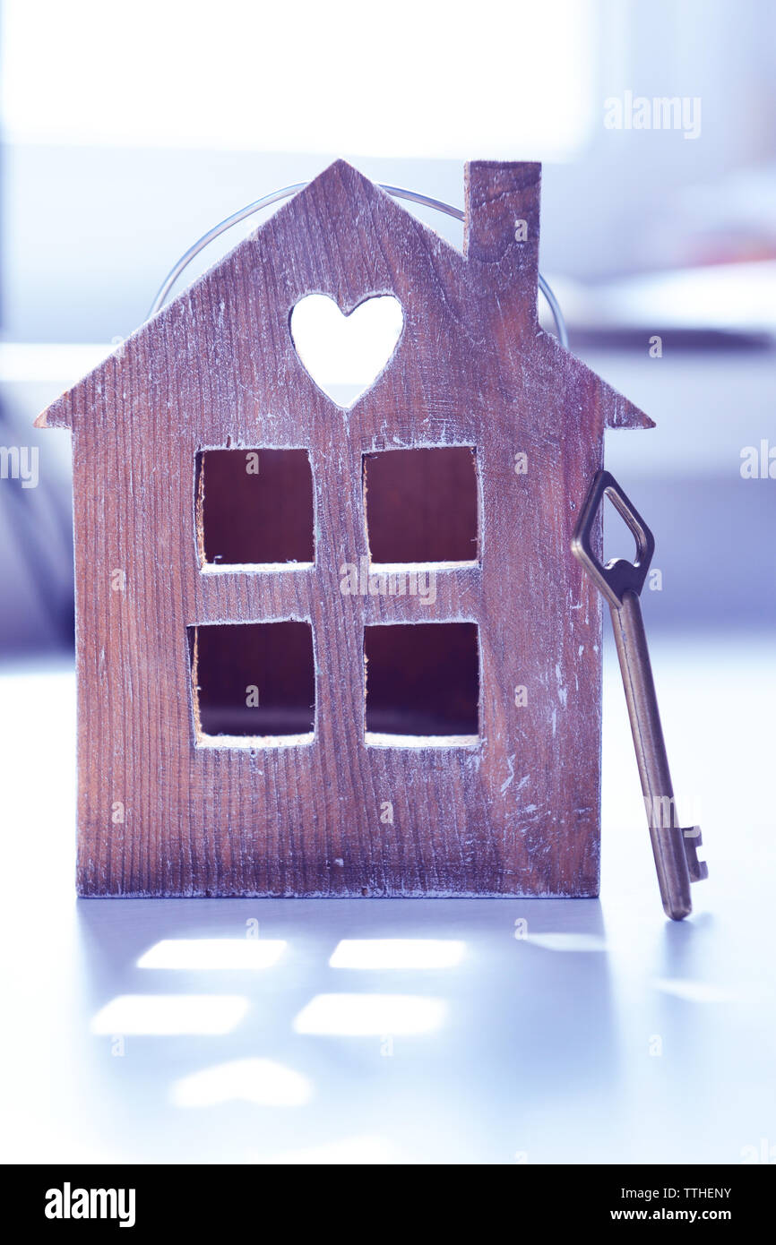 Old key with small wooden house closeup Stock Photo - Alamy