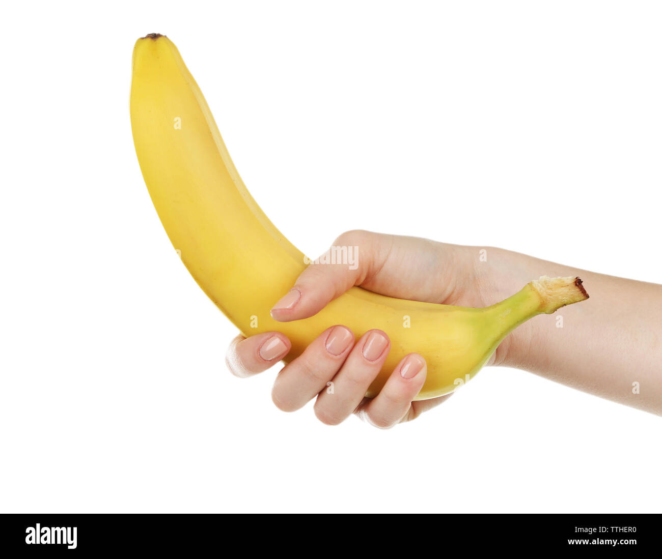 Female hand holding banana isolated on white Stock Photo - Alamy