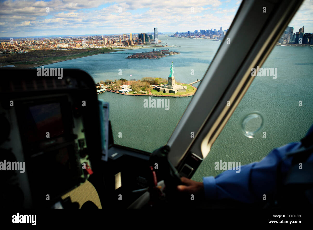 Statue of Liberty amidst bay seen through helicopter window Stock Photo ...
