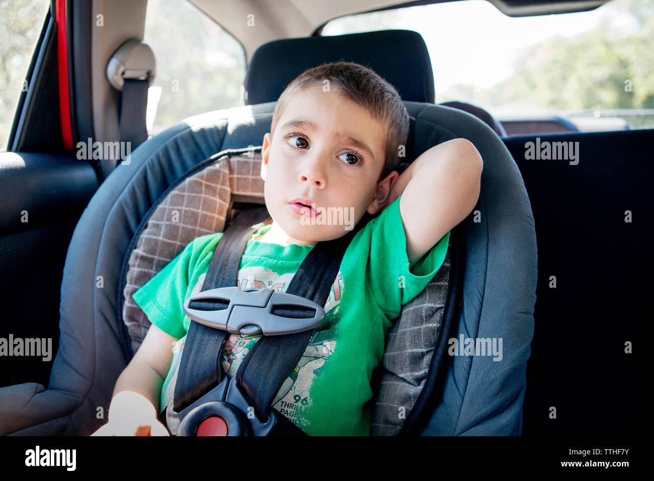 Thoughtful boy sitting in car seat Stock Photo - Alamy