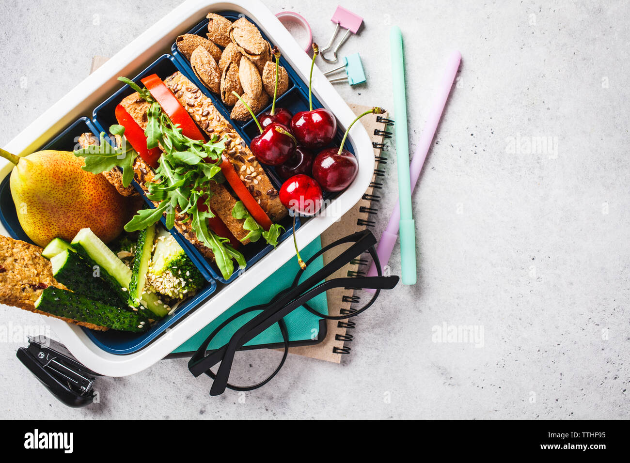 Back to school concept. Lunch box with sandwich, fruit, snacks ...