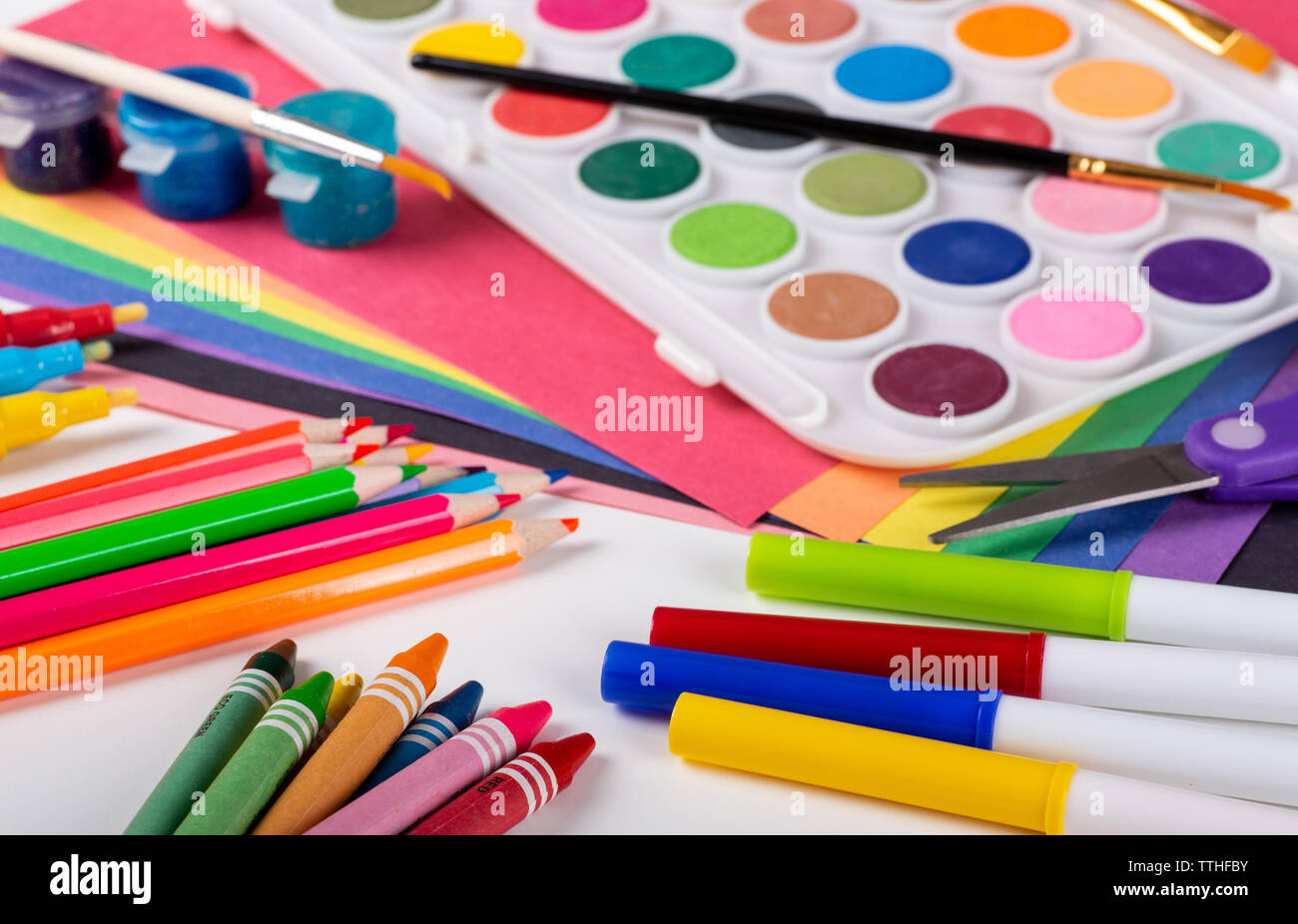 Closeup of an assortment of school craft items on a white background ...