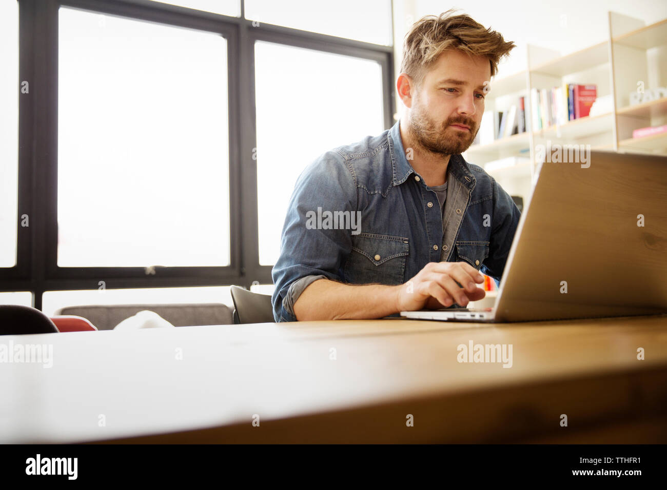 Man using laptop at home Stock Photo - Alamy
