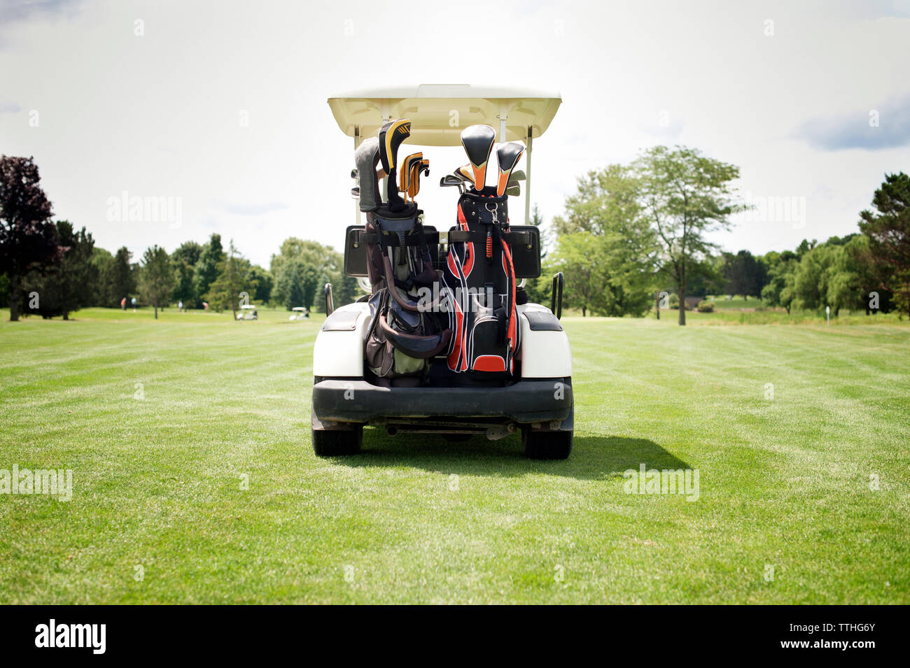 Golf cart parked on golf course Stock Photo - Alamy