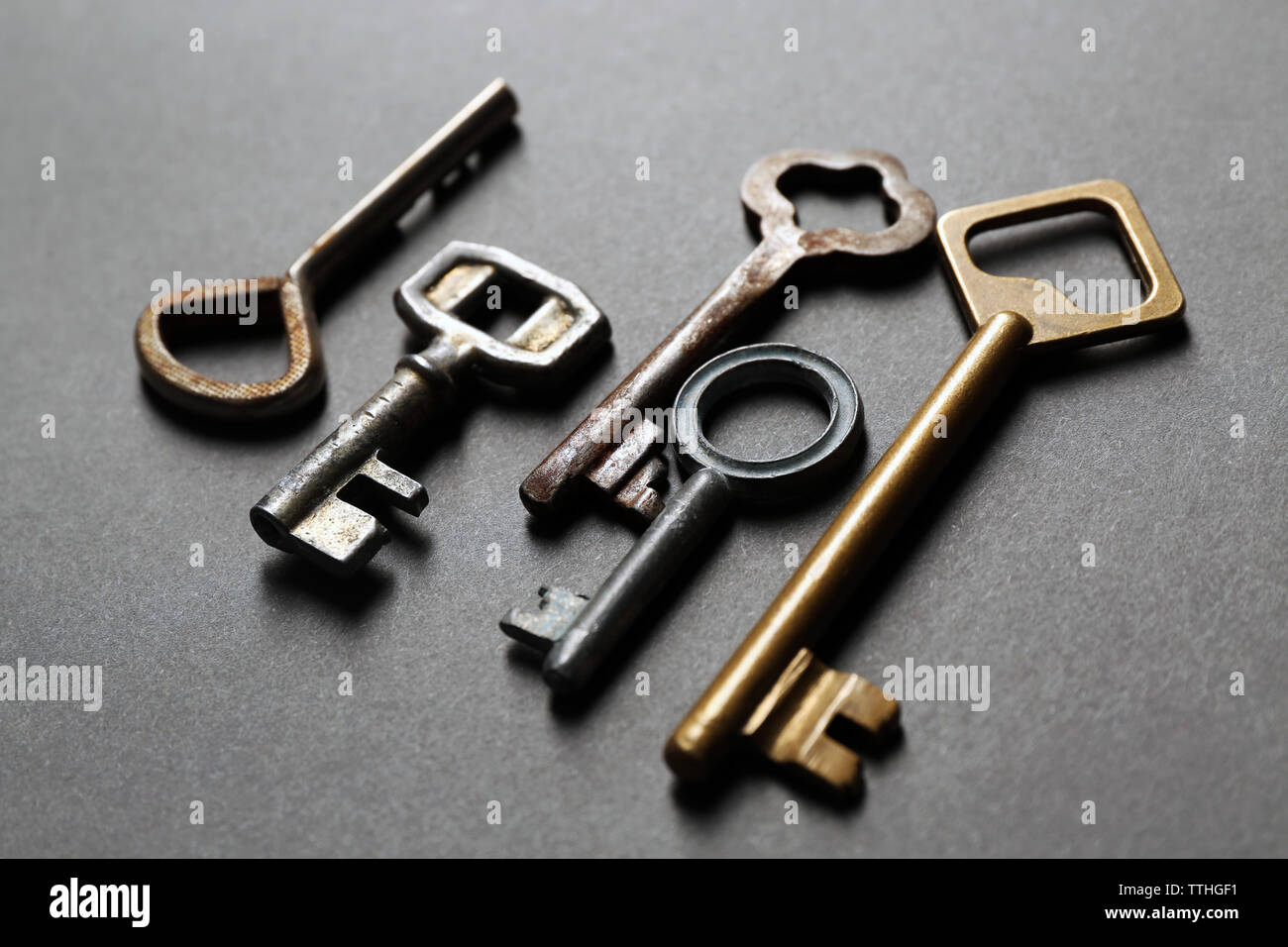 Group of old keys on grey textured background Stock Photo - Alamy