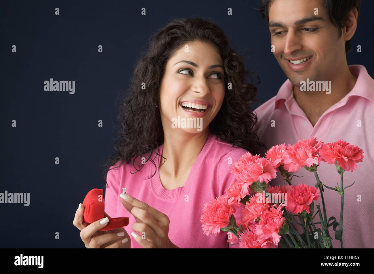 Man giving flowers to a woman Stock Photo - Alamy