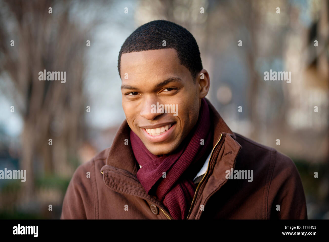 Portrait of smiling young man outdoors Stock Photo - Alamy
