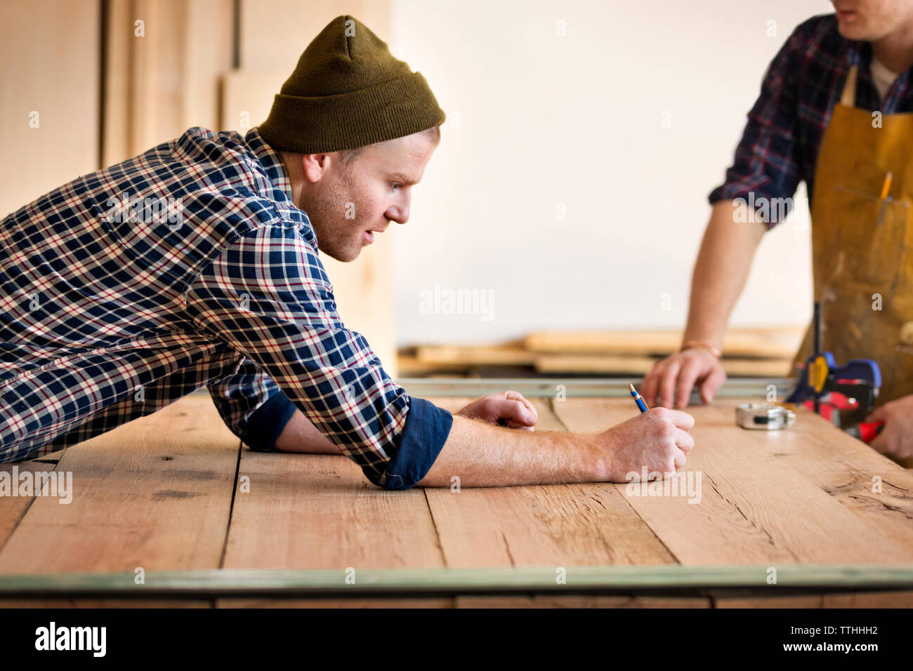 Male carpenter marking on wood at workshop Stock Photo - Alamy