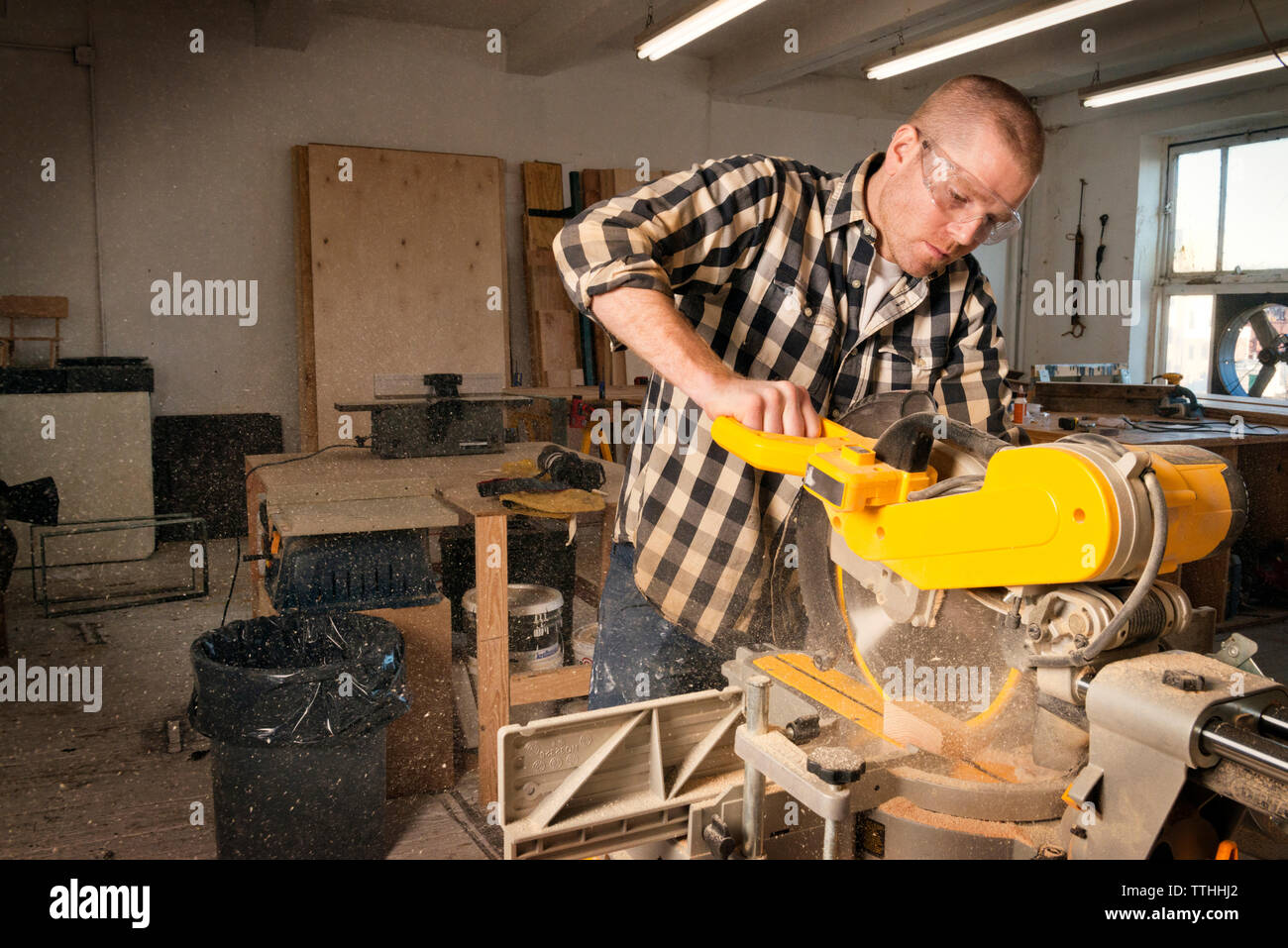 Male carpenter using machinery in workshop Stock Photo - Alamy