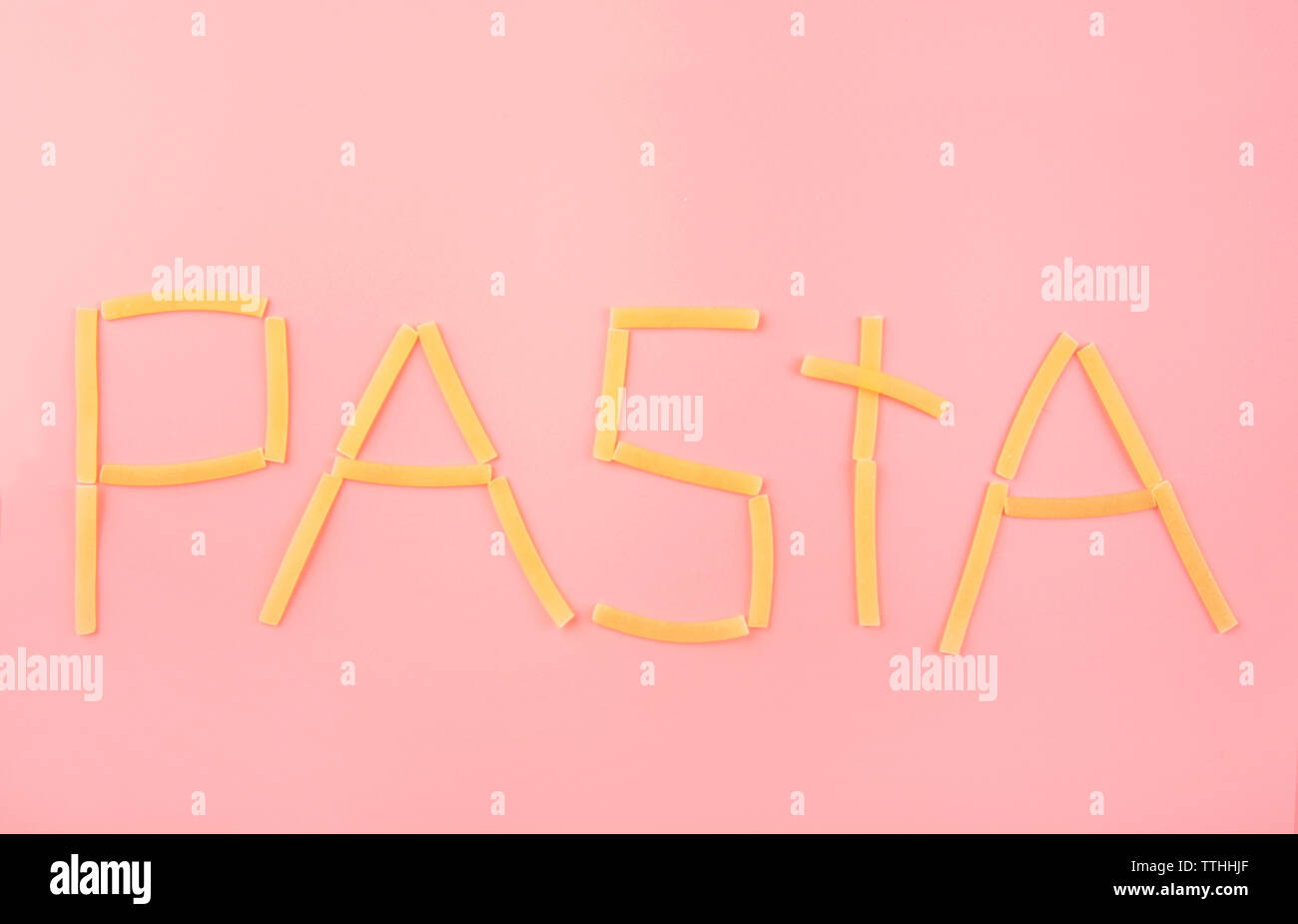 Pasta word made of noodles slices on pink background Stock Photo - Alamy