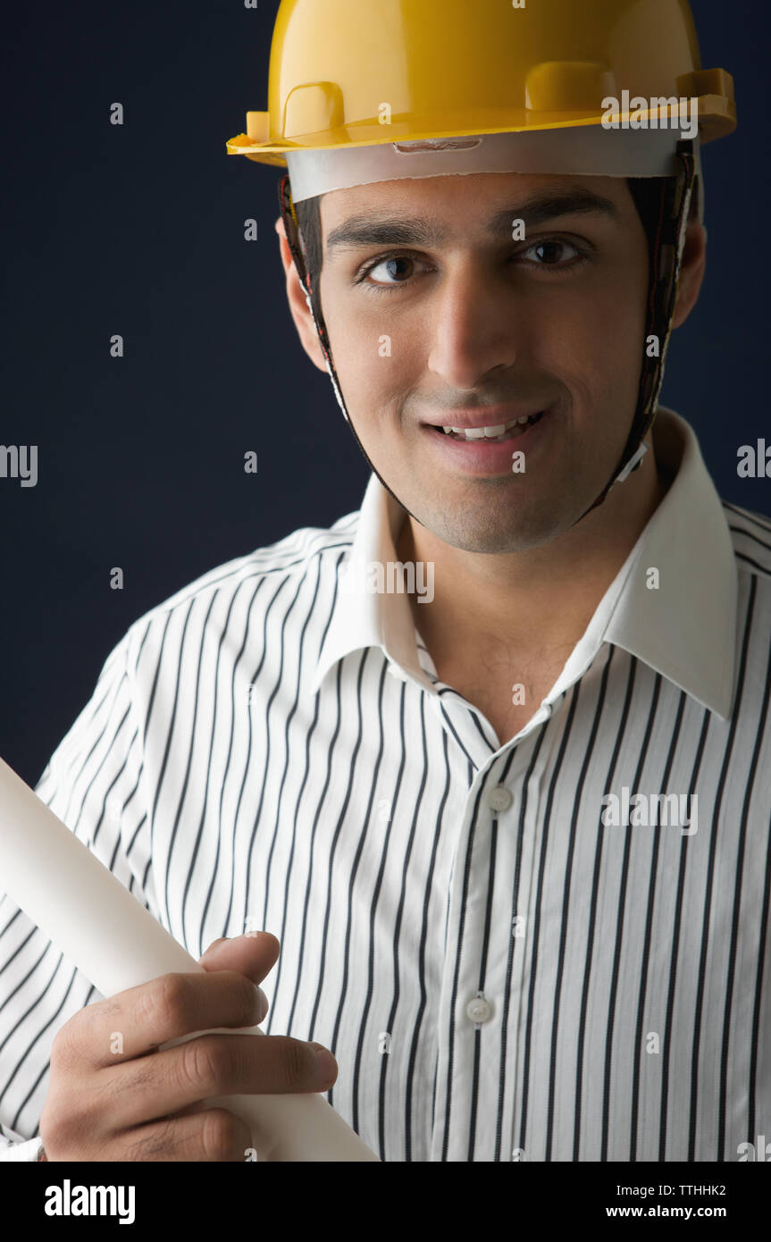 Male architect holding a blueprint Stock Photo - Alamy