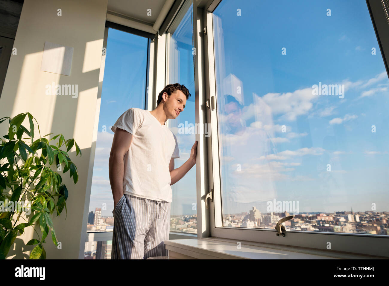 Man looking cityscape through window hi-res stock photography and ...