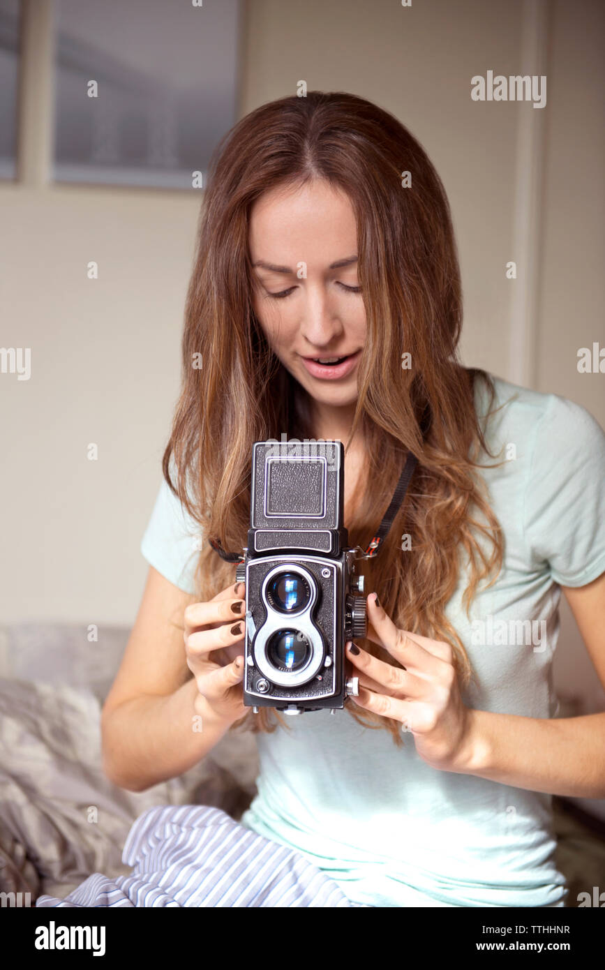 Close-up of woman using camera on bed Stock Photo - Alamy