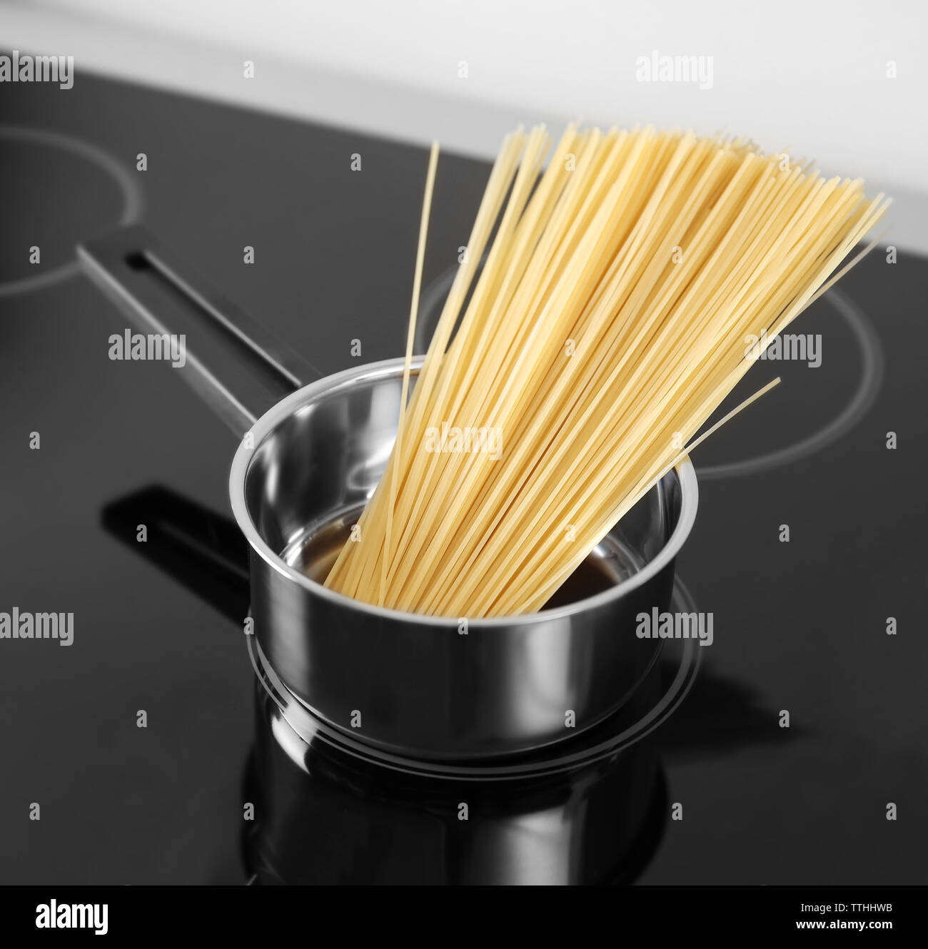 Boiling spaghetti in pan on electric stove in the kitchen Stock Photo ...