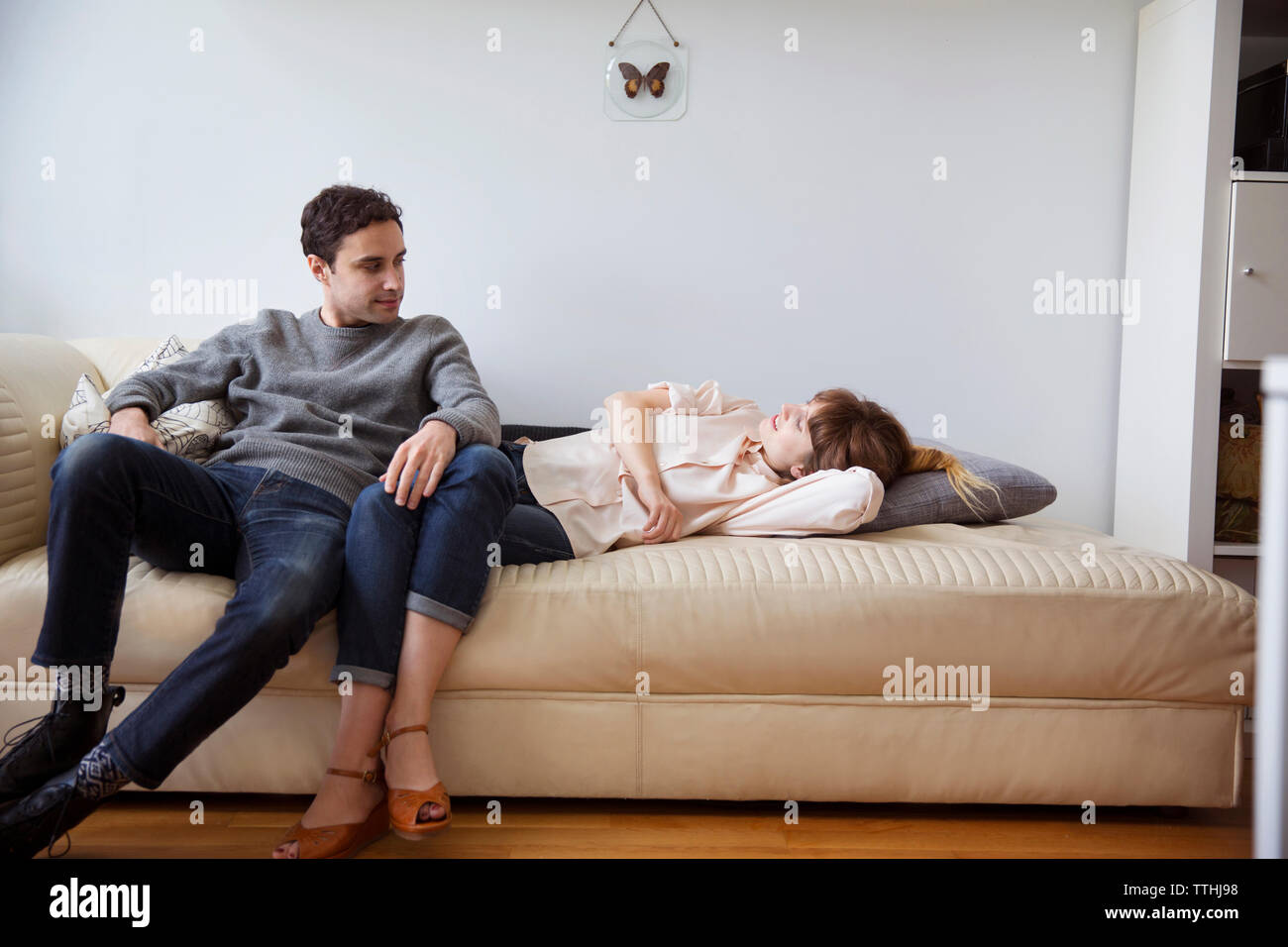 Young woman lying on wall hi-res stock photography and images - Alamy