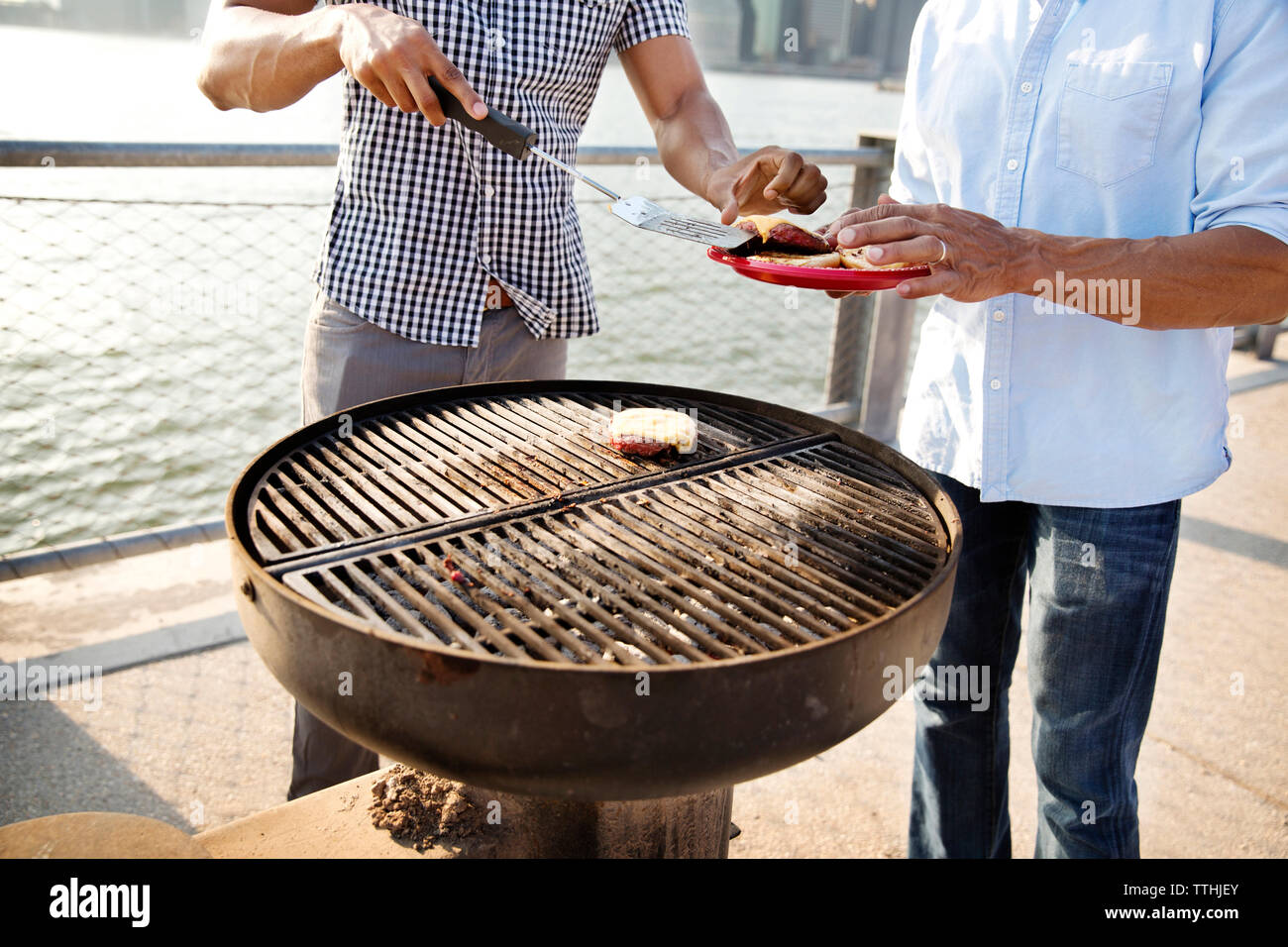 Midsection of man serving food to father while standing at promenade ...