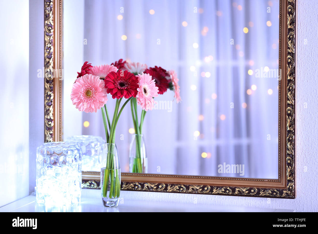 Bouquet of fresh gerbers in vase in front of the mirror indoors Stock ...