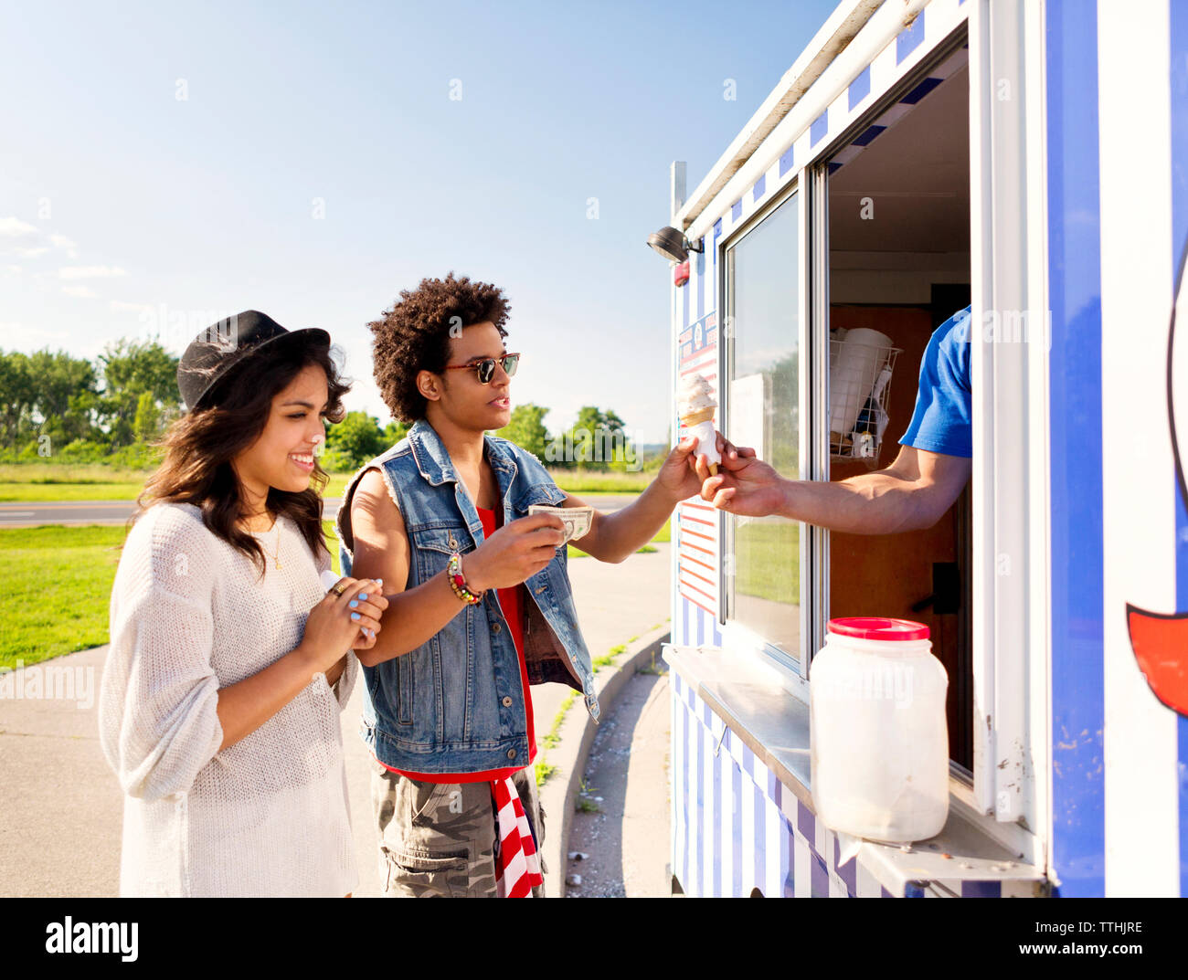 Friends buying ice cream from vendor at food truck Stock Photo - Alamy
