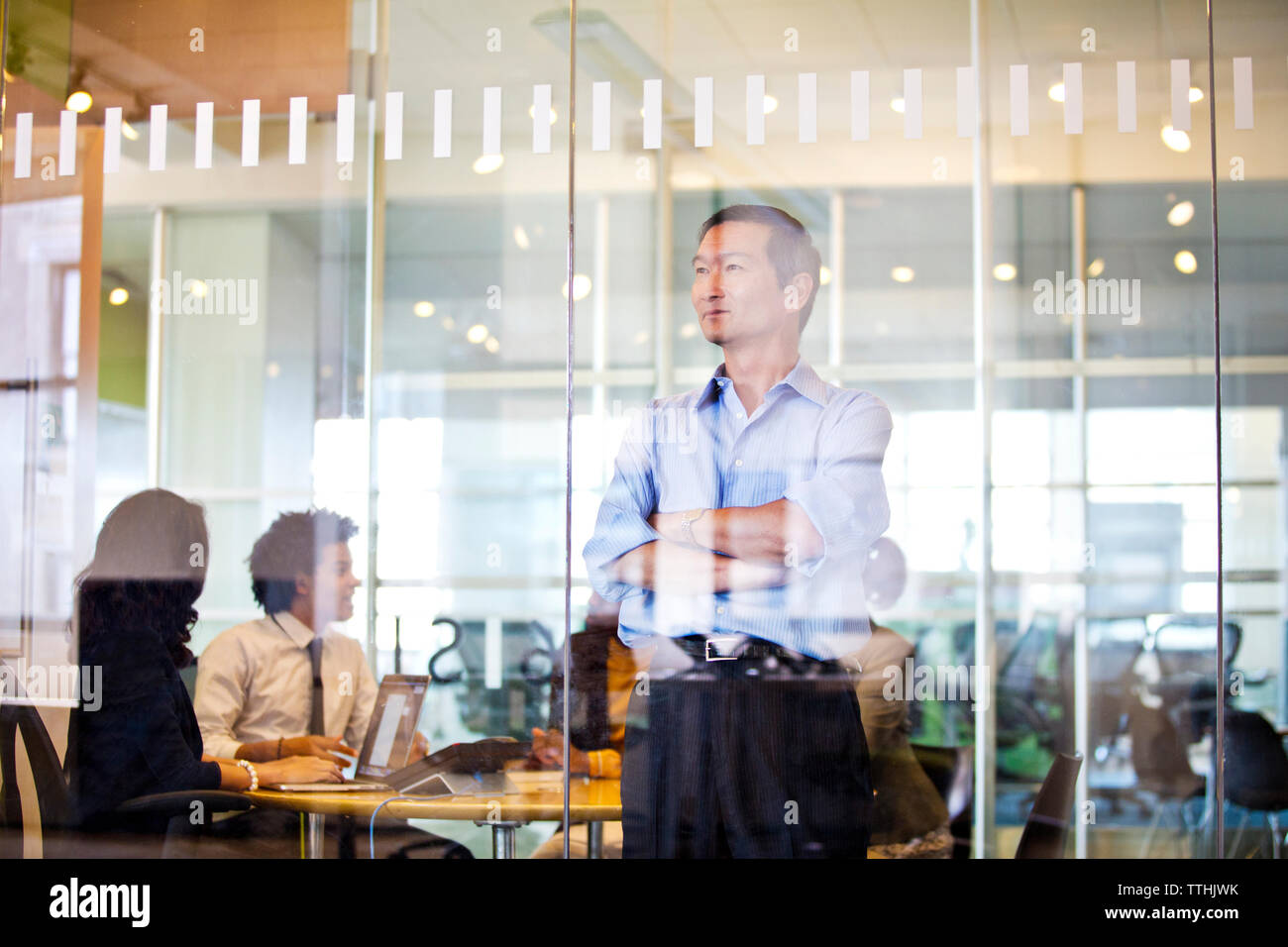 Through glass business people hi-res stock photography and images - Alamy