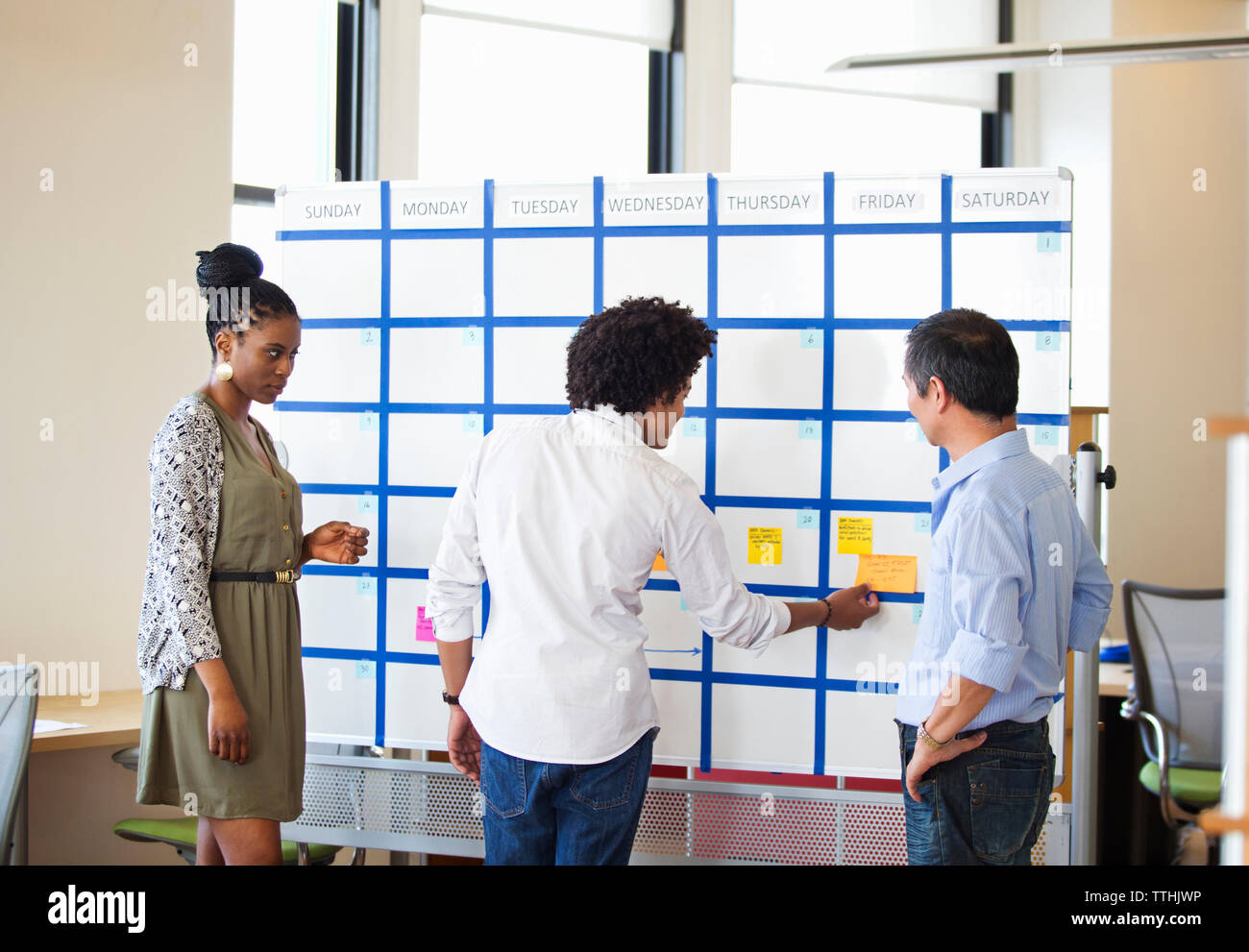 business colleagues planning strategy on whiteboard in office Stock ...