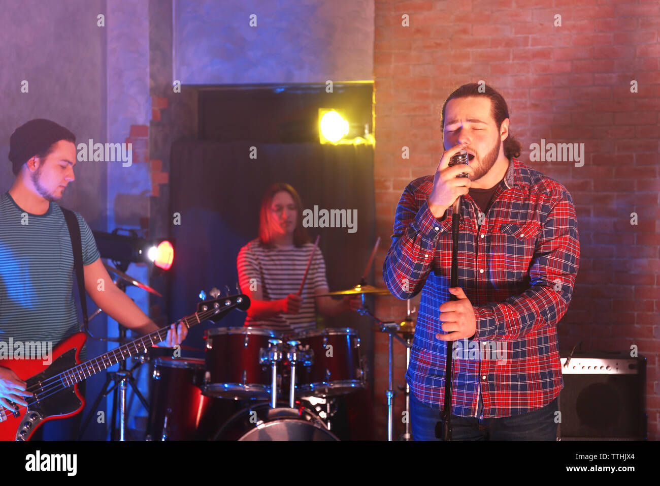 Music band performing on stage Stock Photo - Alamy