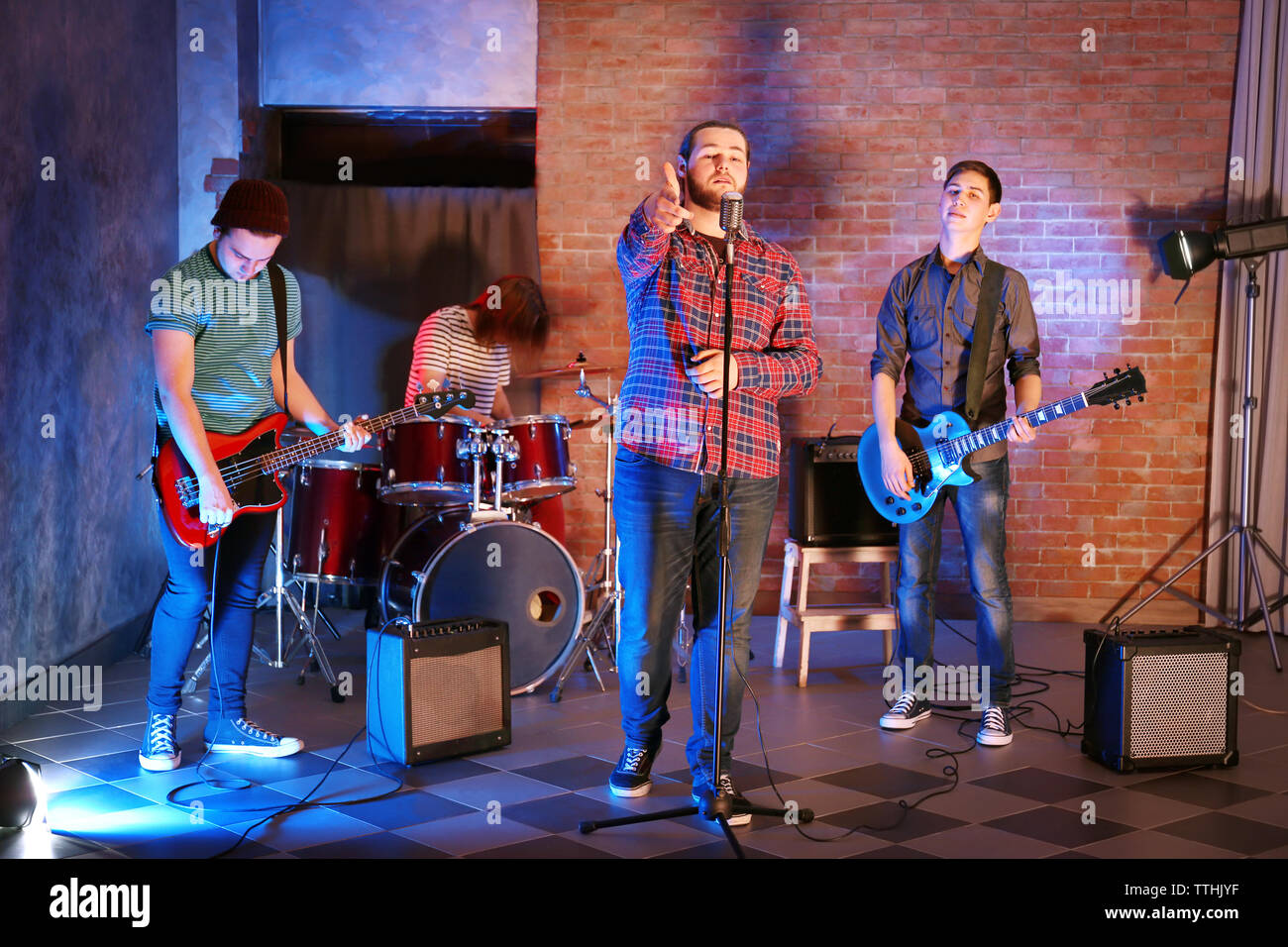 Music band performing on stage Stock Photo - Alamy