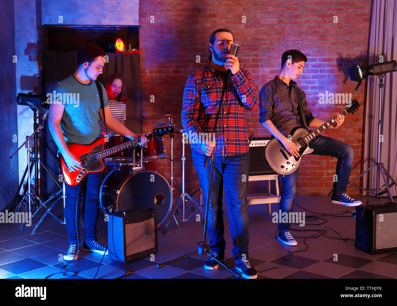 Music band performing on stage Stock Photo - Alamy