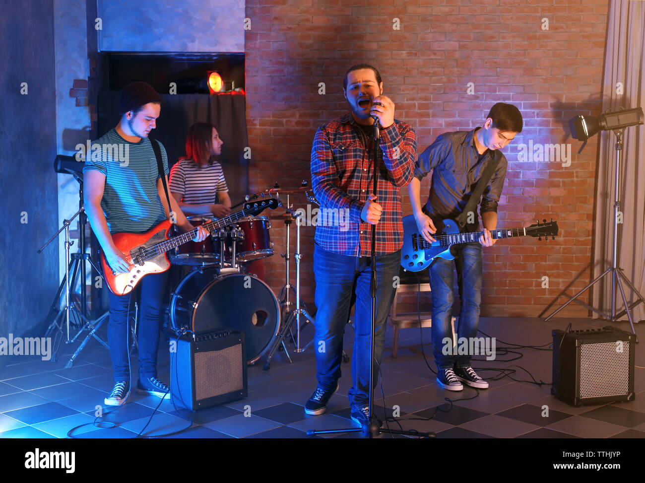 Music band performing on stage Stock Photo - Alamy
