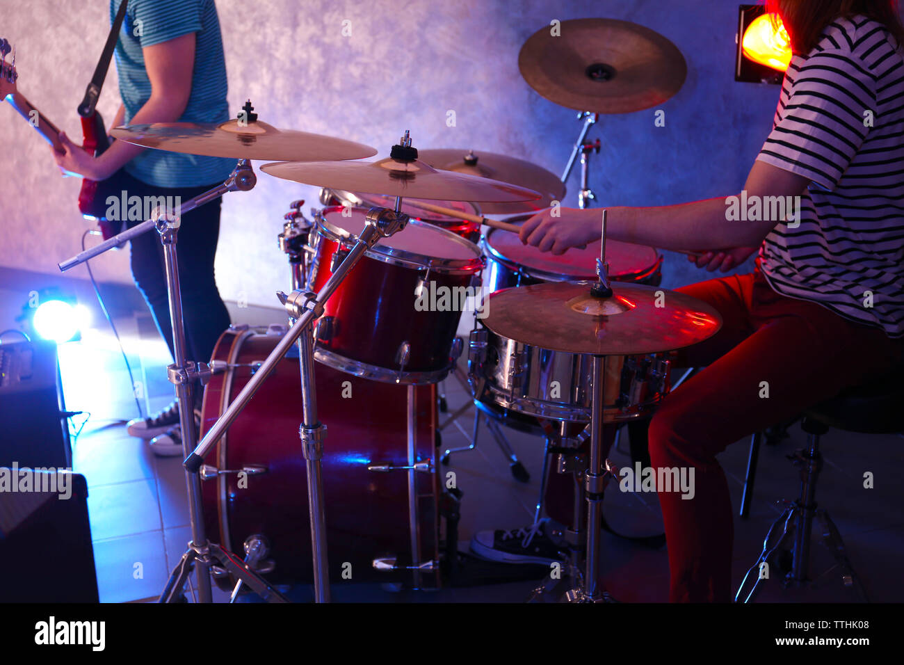 Drummer playing on drum set on stage Stock Photo - Alamy
